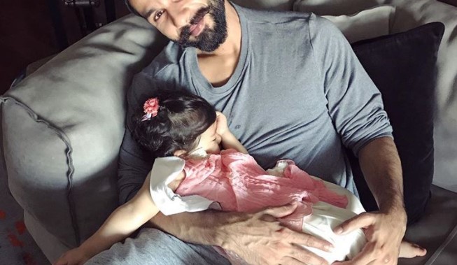 A cuddling Misha in dad Shahid's arms is a sight to behold!