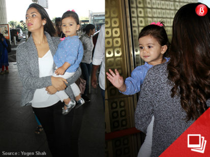 Baby Misha looks adorbs at the airport, tucked in mommy Mira's arms!