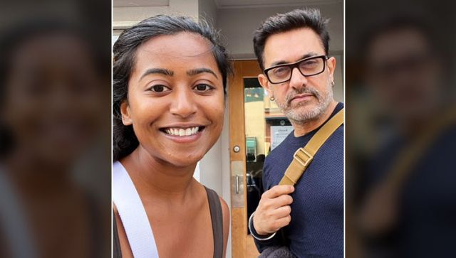 Aamir Khan sports a salt and pepper look as he smiles for a photo with fan